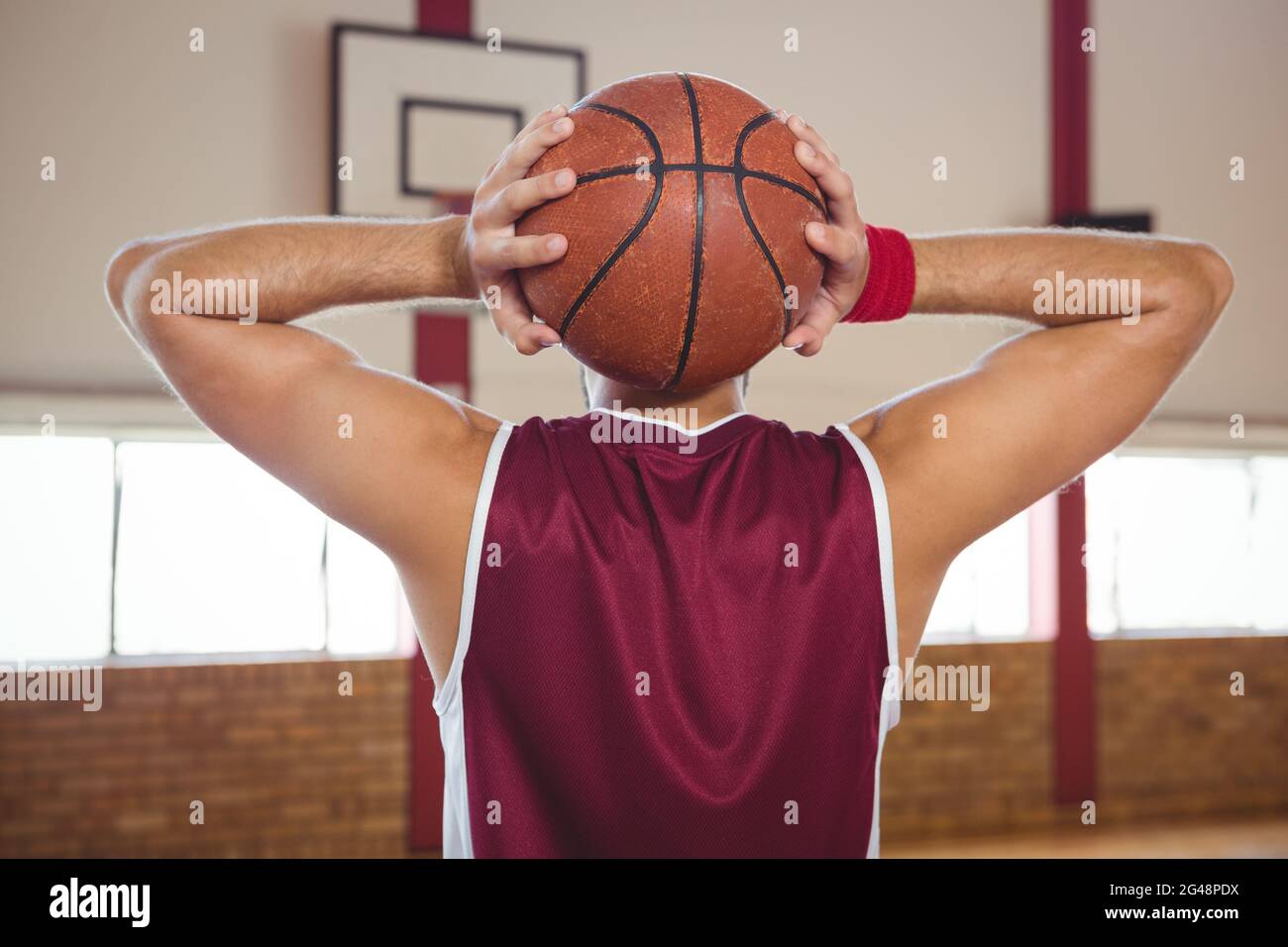 Rear view of basketball player with ball in court Stock Photo - Alamy