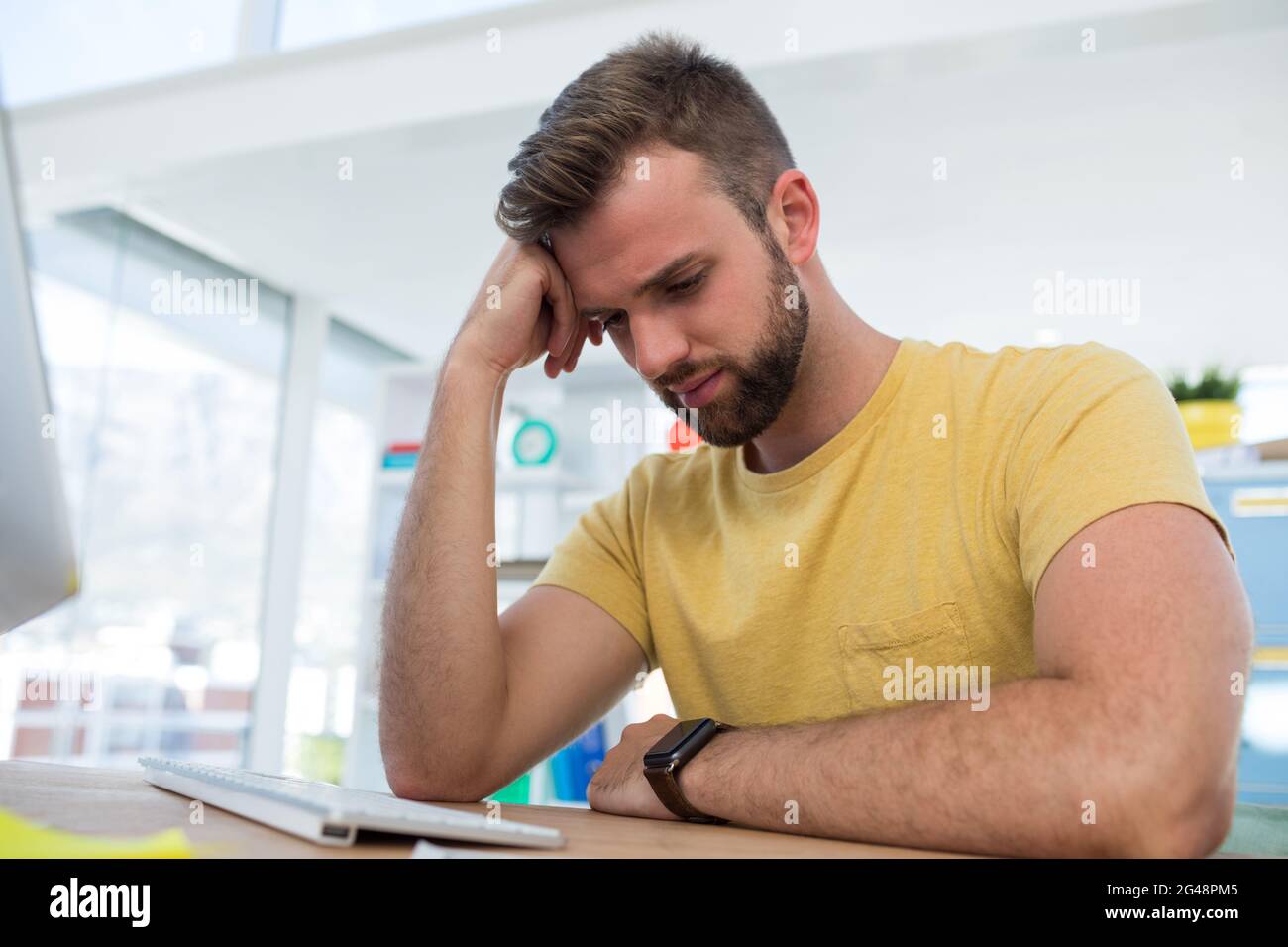 Depressed male executive working on computer Stock Photo - Alamy