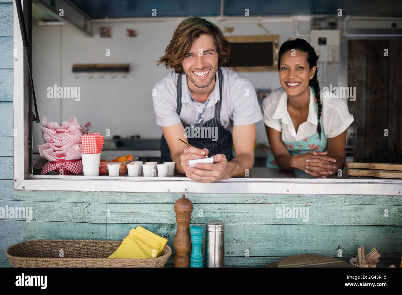 Portrait of waiter and waitress smiling Stock Photo - Alamy