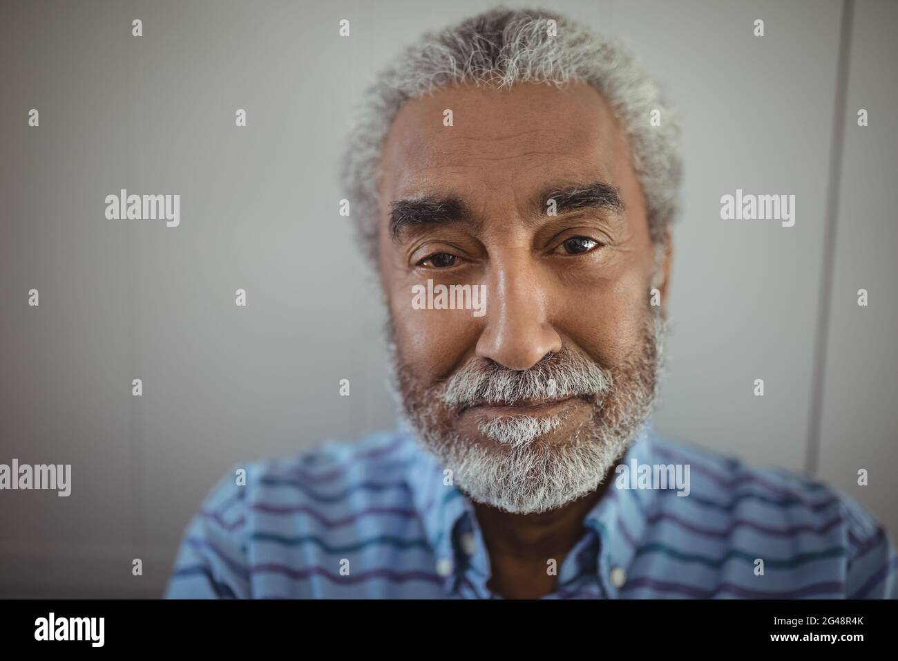 Senior man looking at camera Stock Photo - Alamy