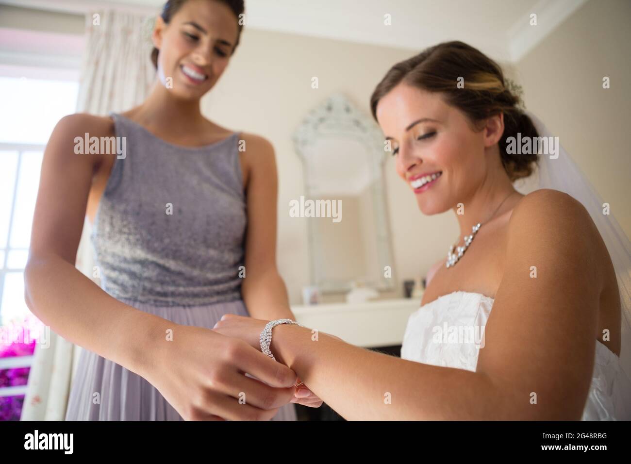 Woman helping bride dressed hi-res stock photography and images - Alamy