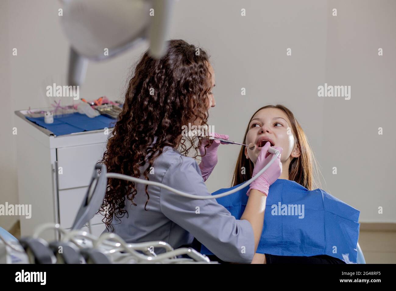 Professional doctor dentist examine and treat spoiled teeth with the ...