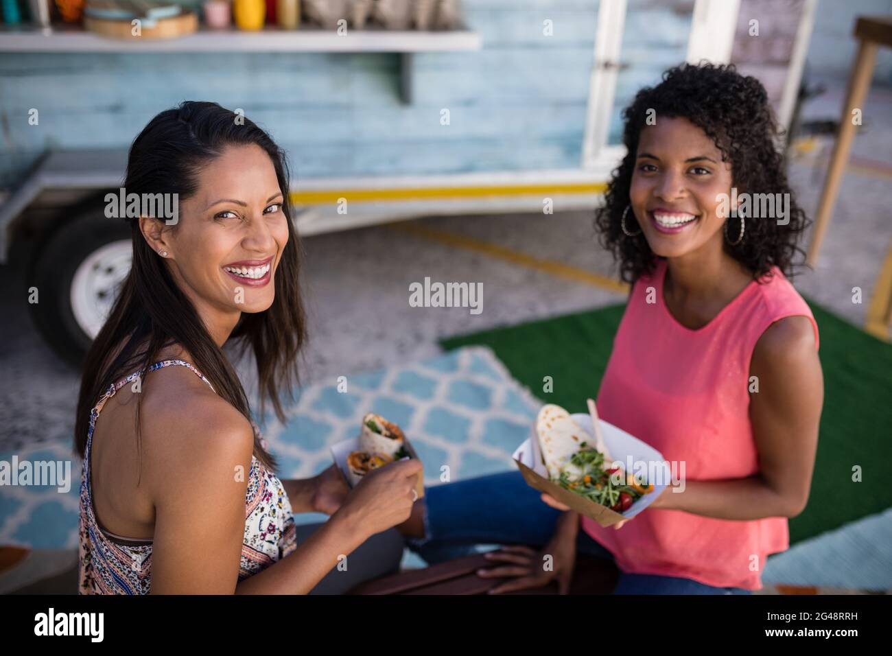 Happy friends having snacks Stock Photo - Alamy