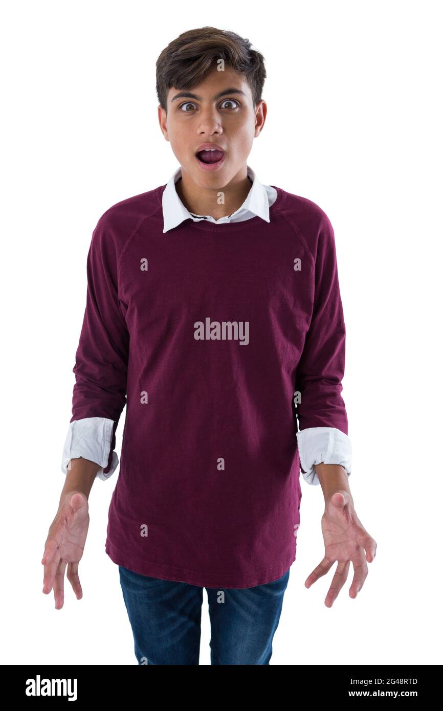 Shocked teenage boy standing against white background Stock Photo - Alamy