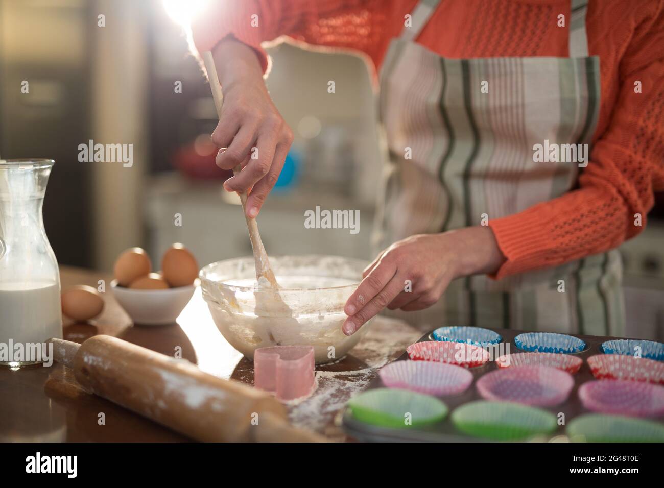 Woman mixing eggs and wheat flour in a bowl Stock Photo - Alamy