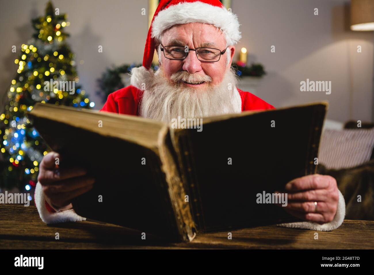 Santa Claus reading book Stock Photo - Alamy