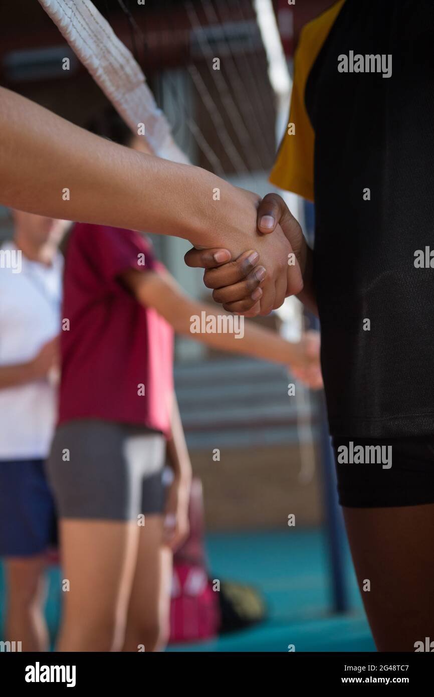 Female players shaking hands after match Stock Photo - Alamy