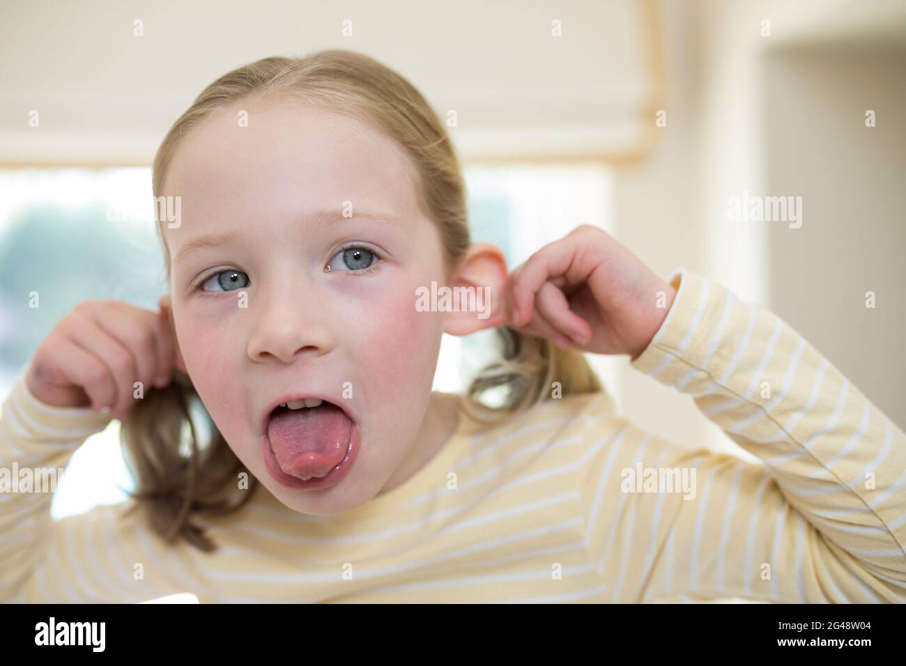 Young girl making funny faces Stock Photo - Alamy