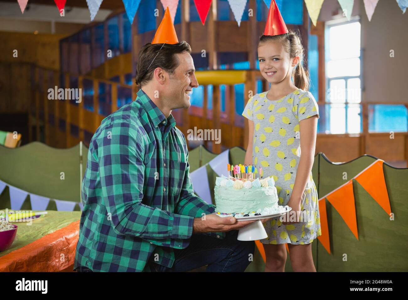 Father giving surprised birthday cake to her daughter Stock Photo - Alamy