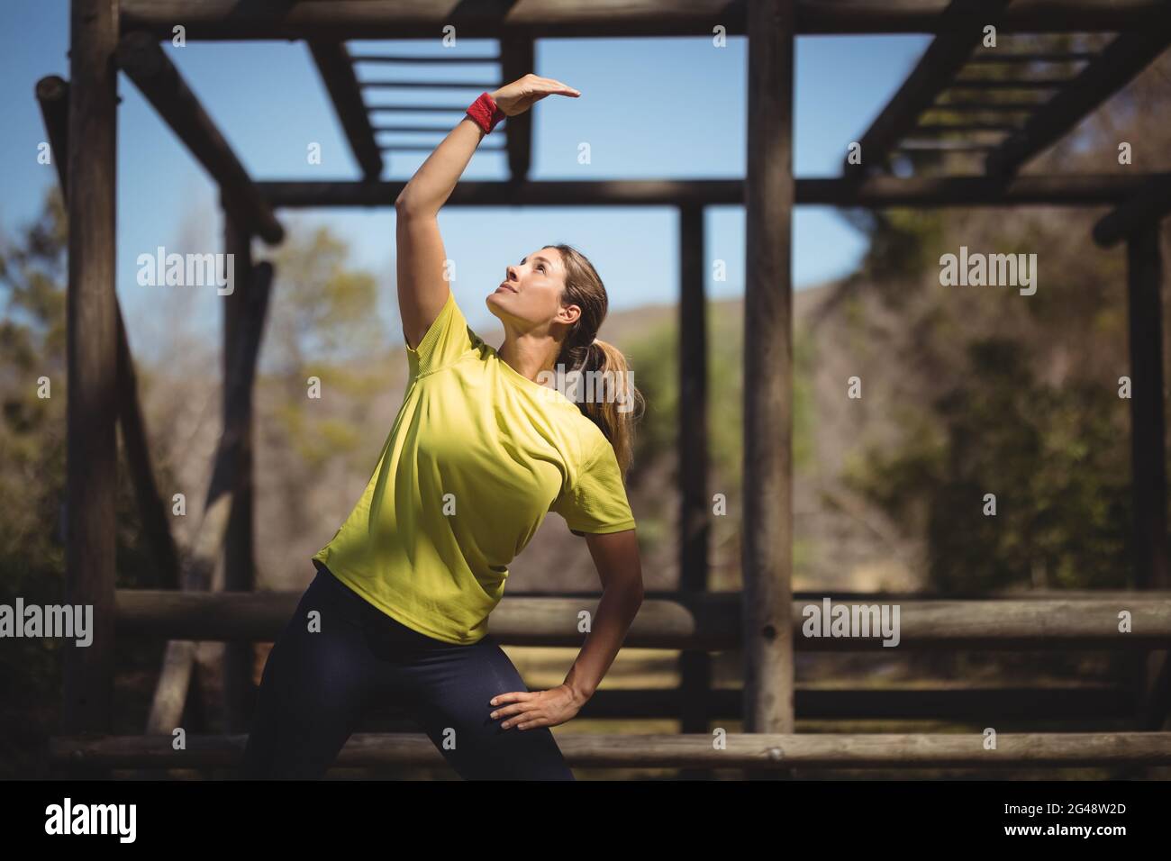 Woman exercising during obstacle course Stock Photo - Alamy