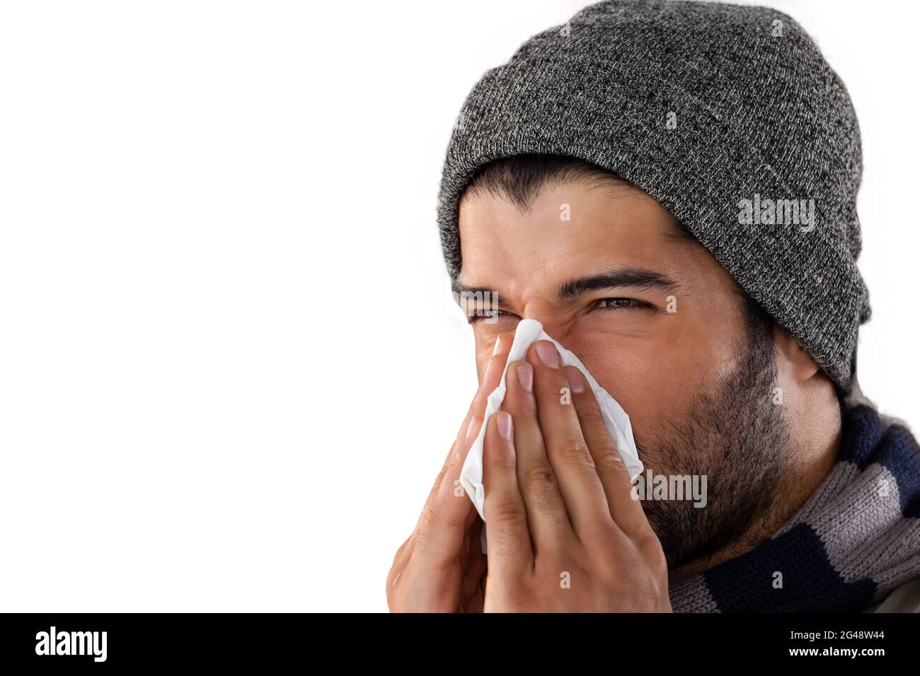 Man blowing his nose with tissue paper Stock Photo - Alamy