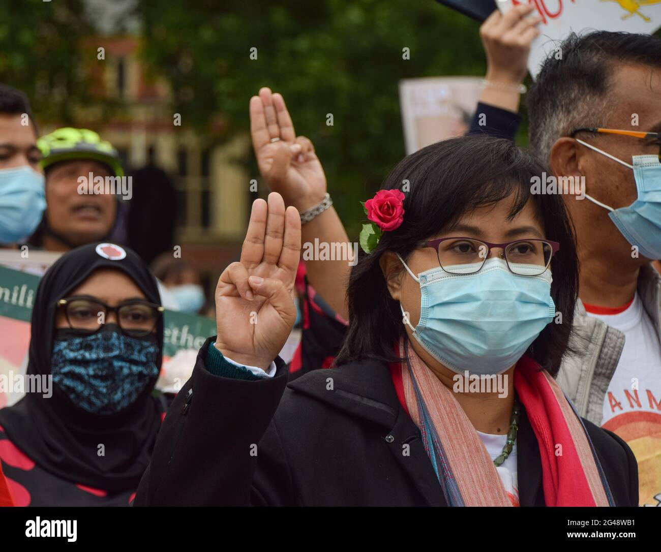 A protester holds up the three-finger salute in Parliament Square ...