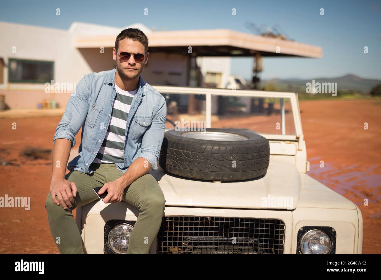 Man relaxing on a car Stock Photo - Alamy
