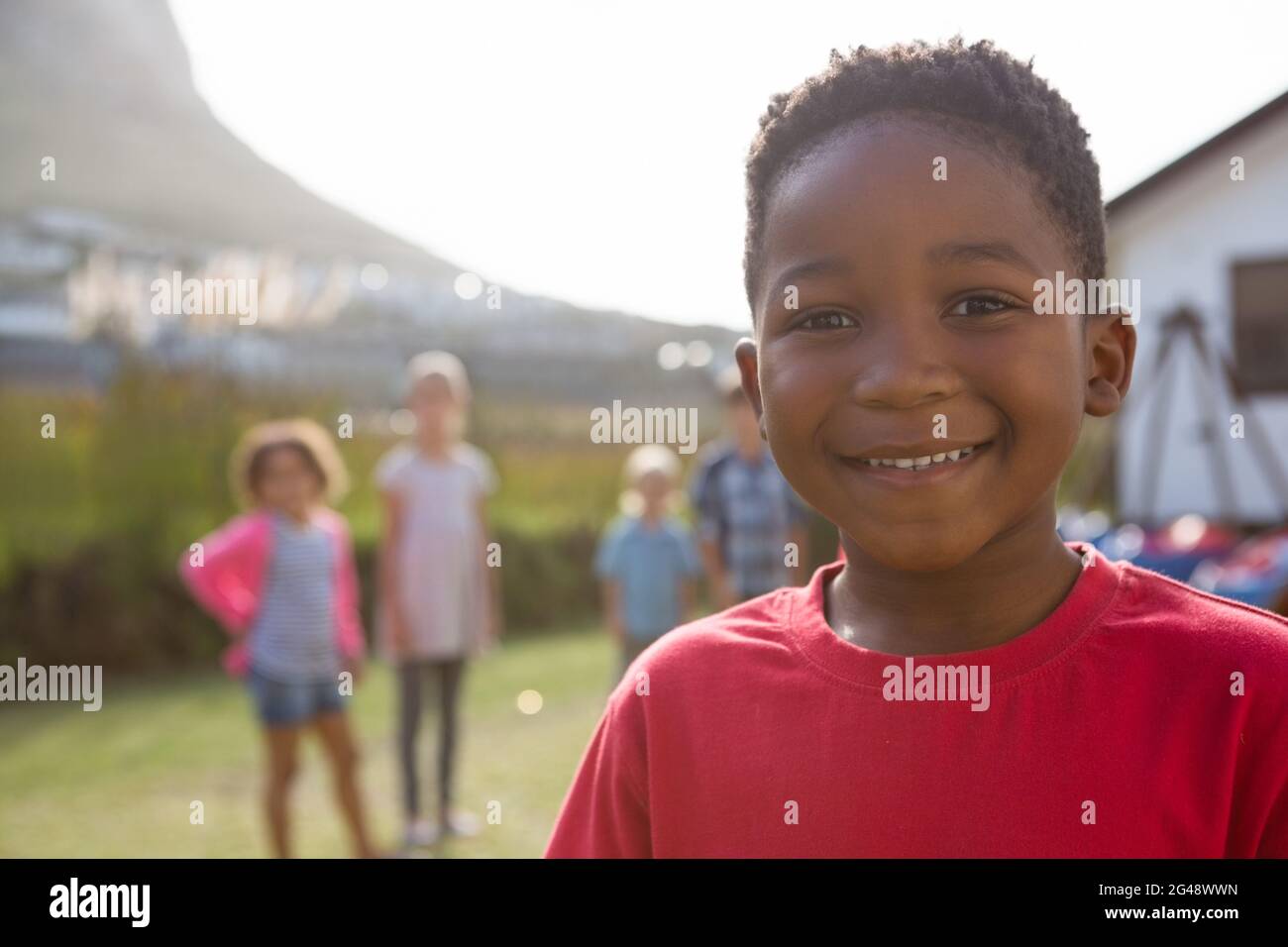 Portrait of happy boy with friends playing in background Stock Photo ...