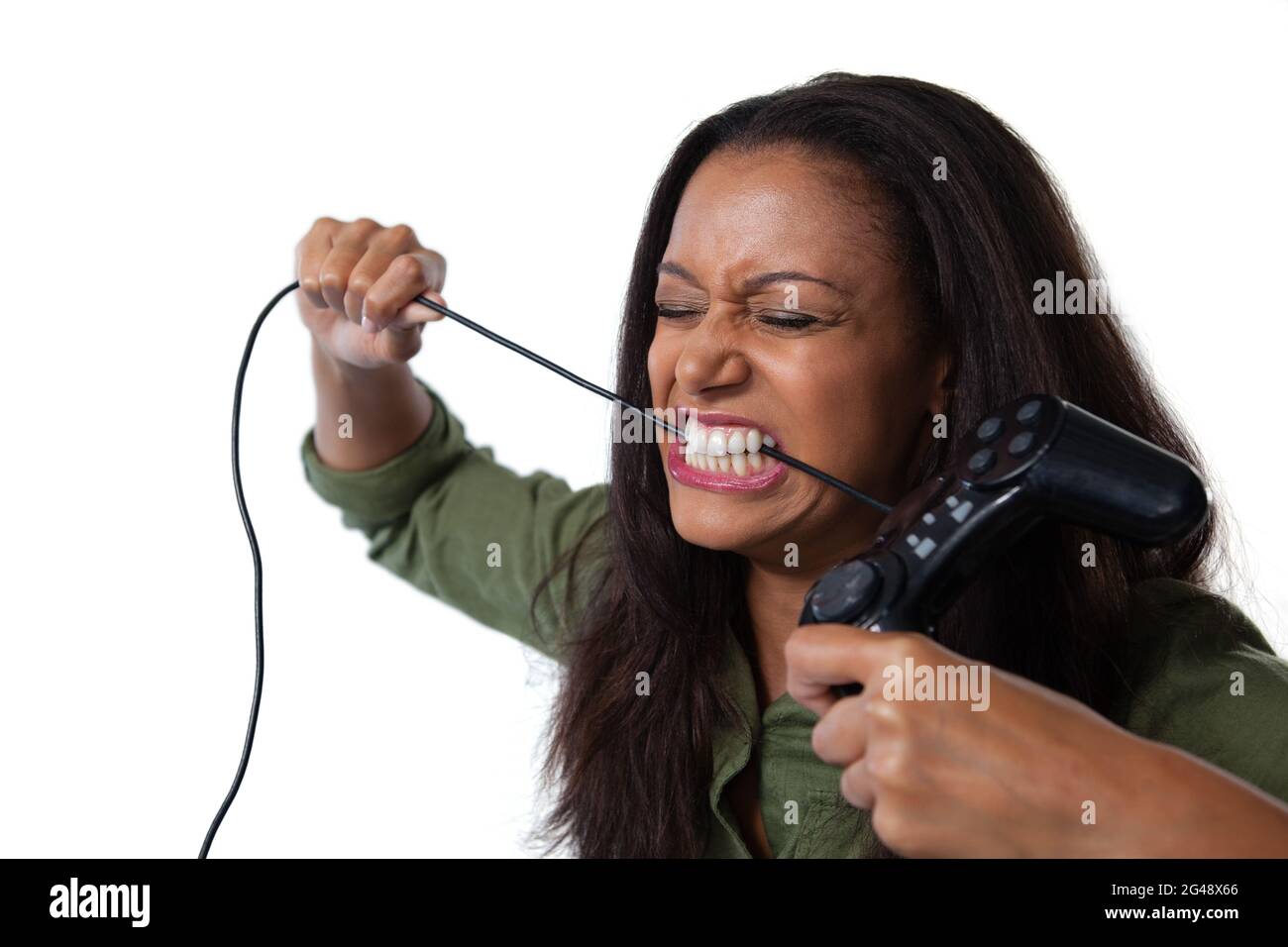 Frustrated woman biting a wire of joystick Stock Photo - Alamy
