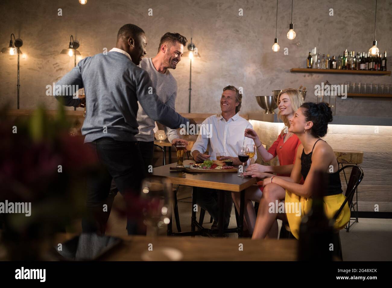 Friends interacting with each other having while having meal Stock ...