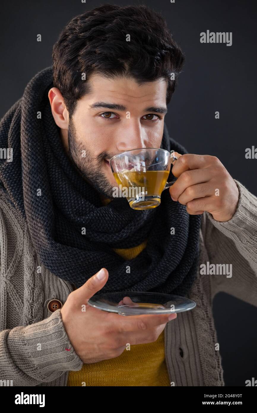 Smiling man having a cup of lemon tea Stock Photo - Alamy