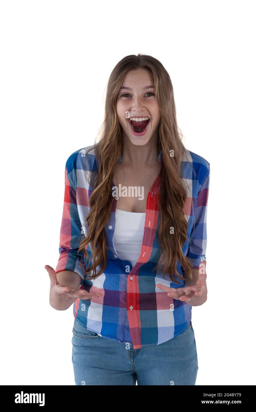 Teenage girl standing against white background Stock Photo - Alamy