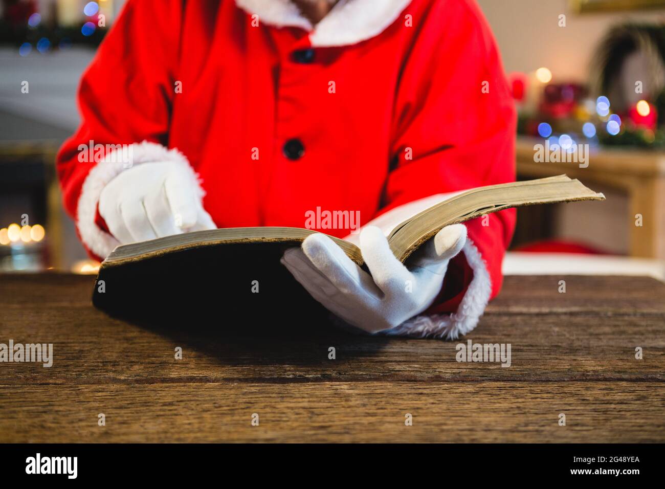 Santa Claus reading book Stock Photo - Alamy