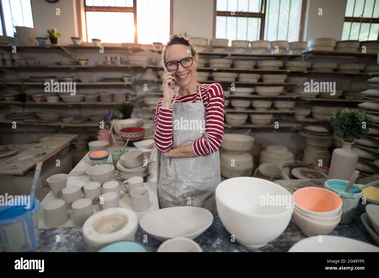 Woman phone call pottery hi-res stock photography and images - Alamy