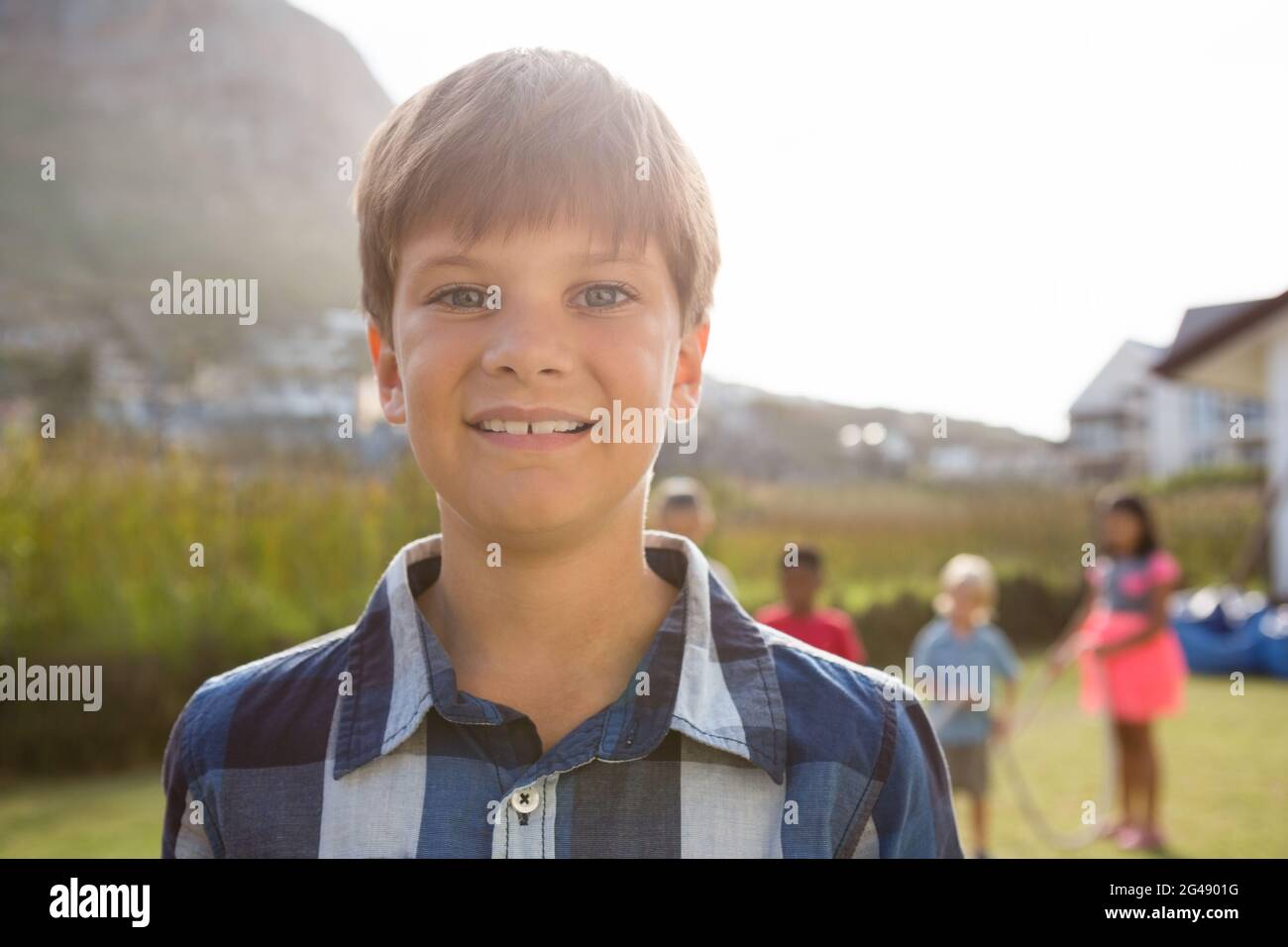 Portrait of smiling boy with friends playing in background Stock Photo ...