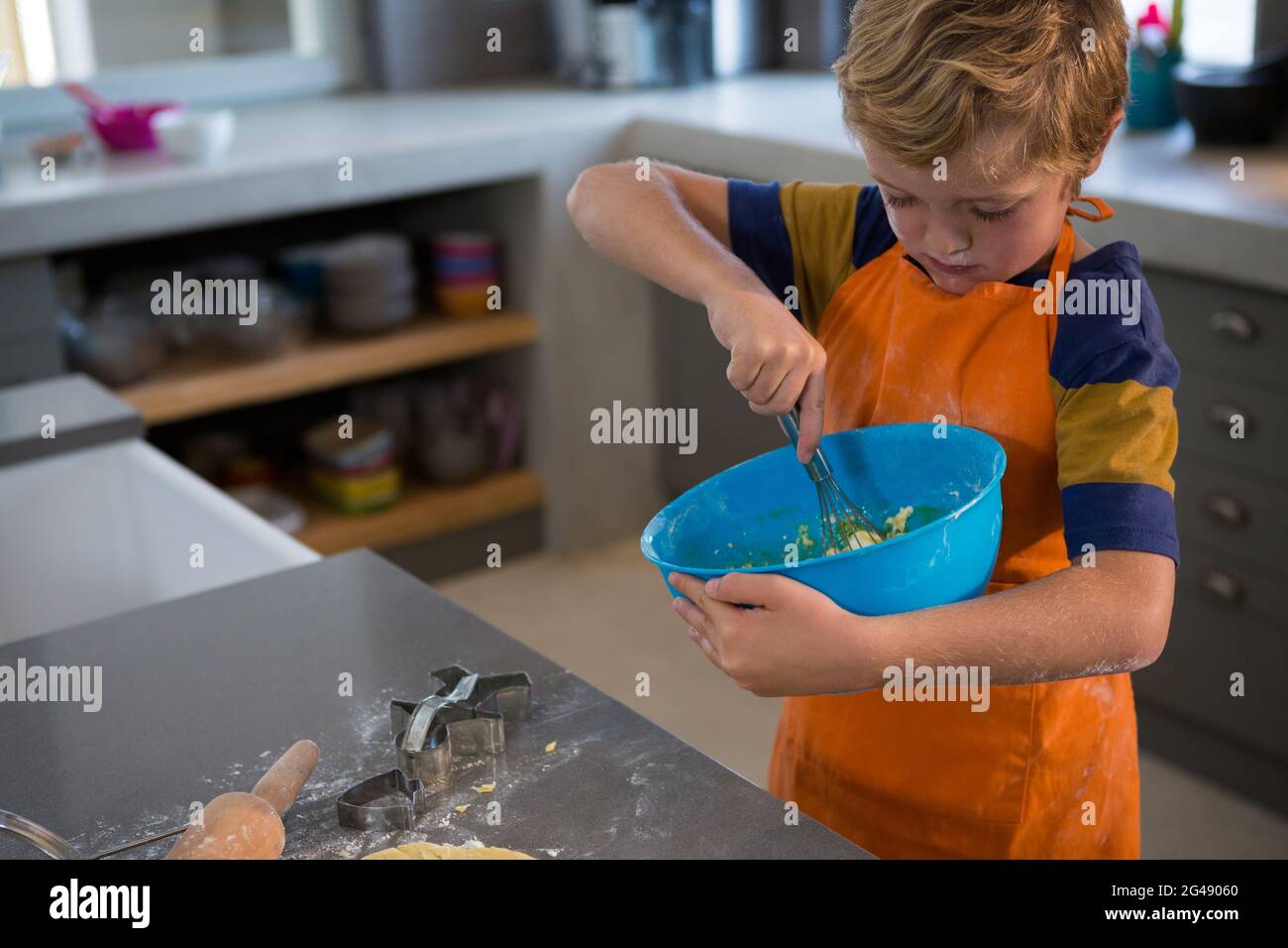 Boy mixing batter in bowl Stock Photo - Alamy