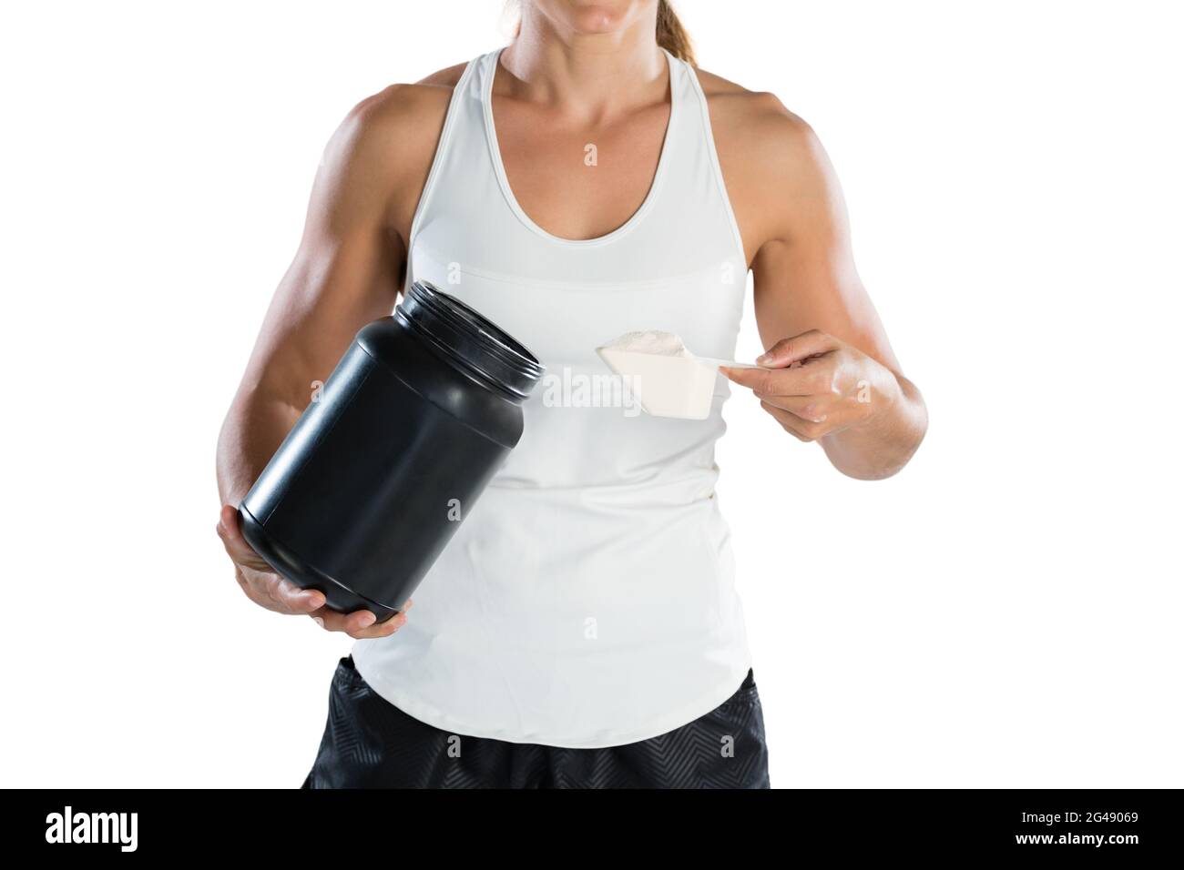 Mid section of female athlete taking supplement powder Stock Photo - Alamy