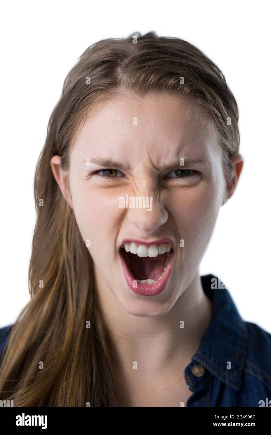 Teenage girl shouting against white background Stock Photo - Alamy