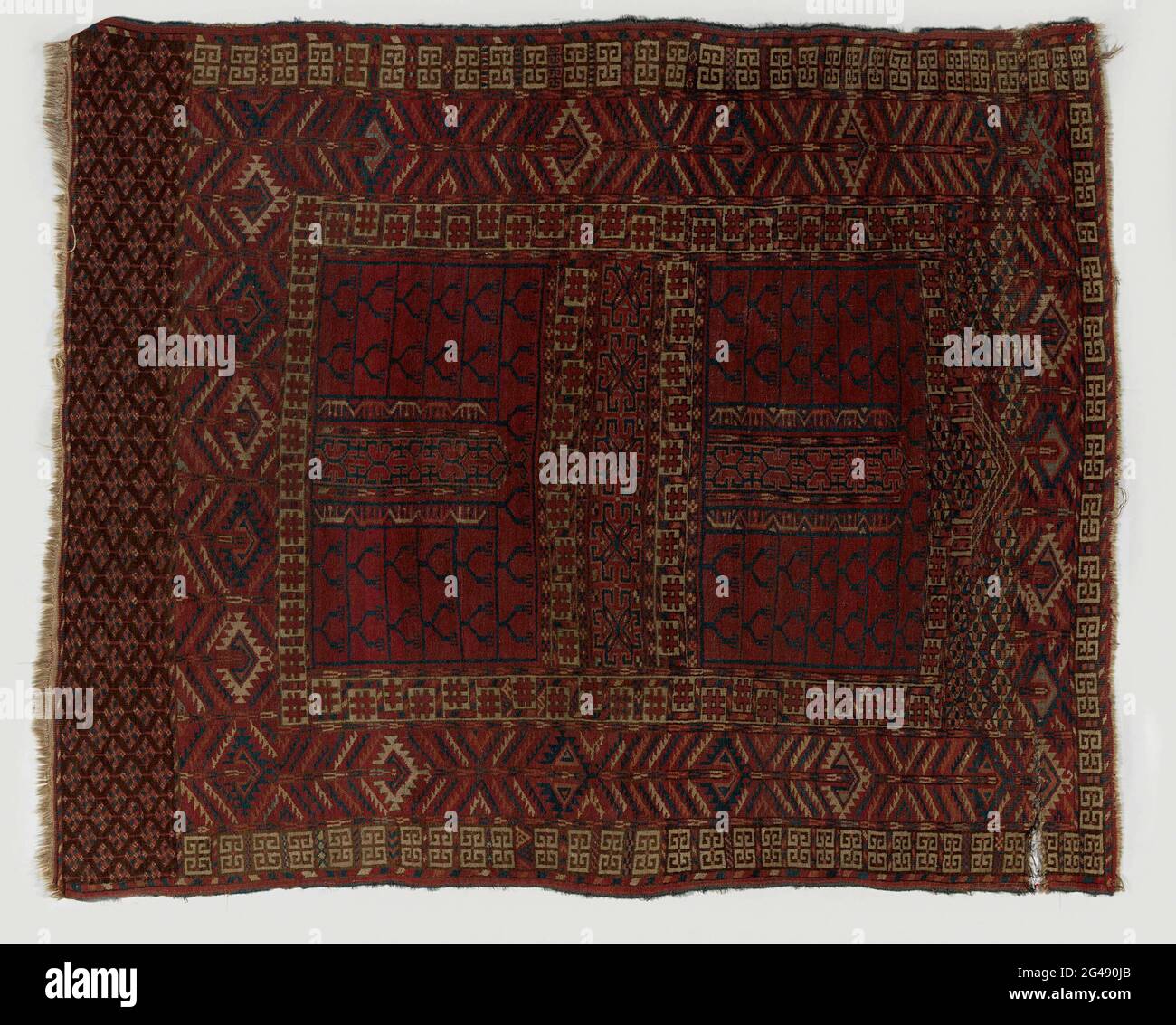 Oriental carpet. Oriental wool carpet of which is shared in two with ...