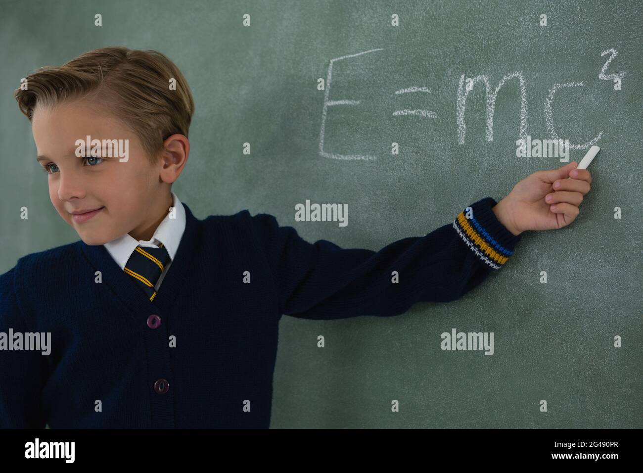 Schoolboy solving maths formula on chalkboard Stock Photo - Alamy