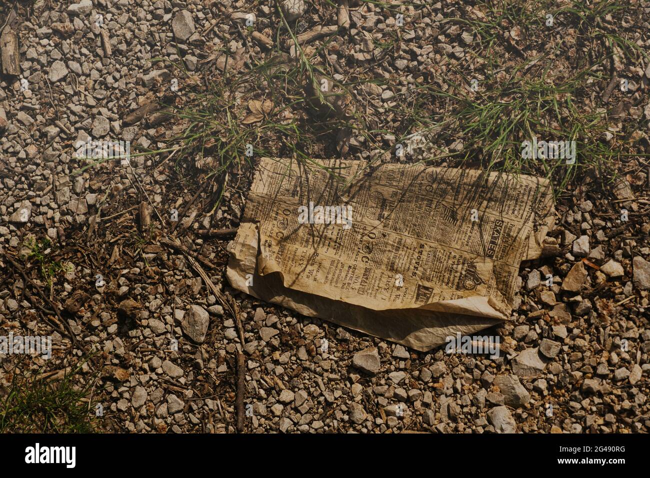 Old weathered newspaper fallen on the ground Stock Photo - Alamy