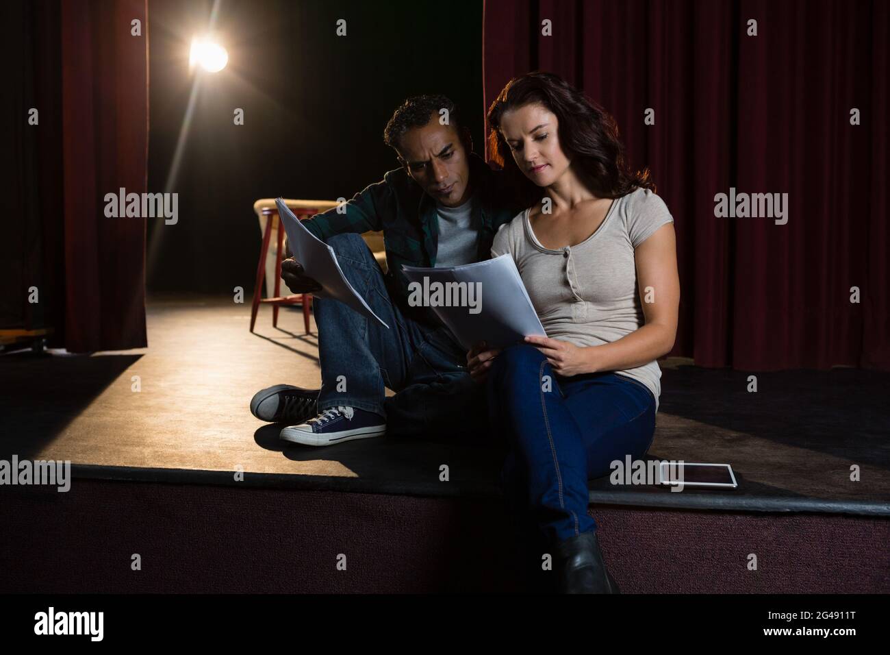 Actors reading their scripts on stage Stock Photo - Alamy