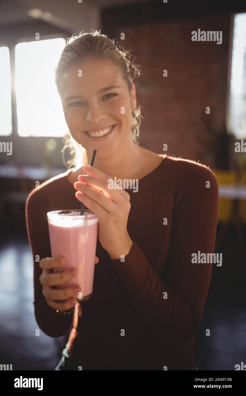 Portrait happy woman drinking milkshake hi-res stock photography and ...