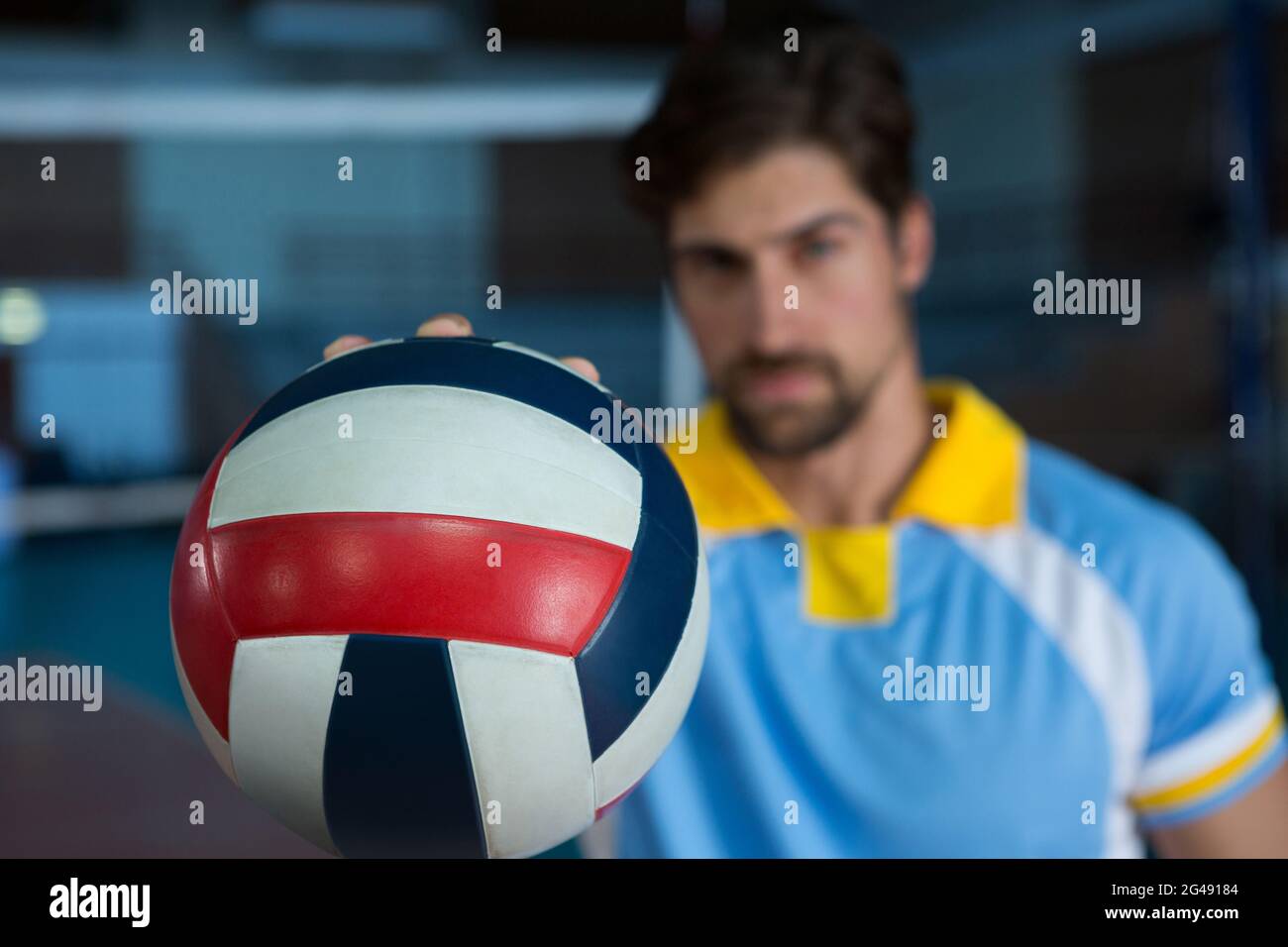 Male sportsperson holding volleyball Stock Photo - Alamy