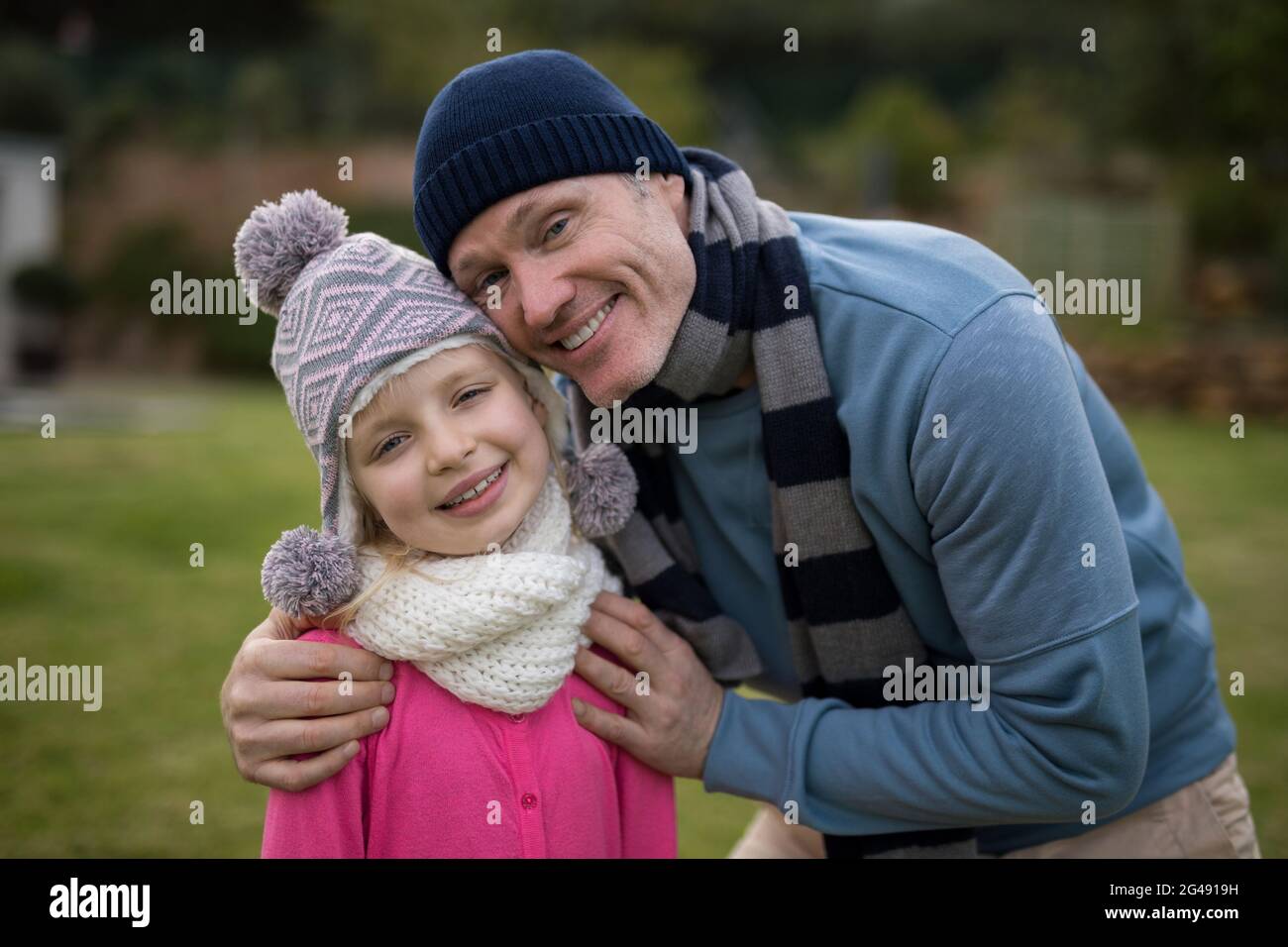 Smiling father and son standing together in the garden Stock Photo - Alamy