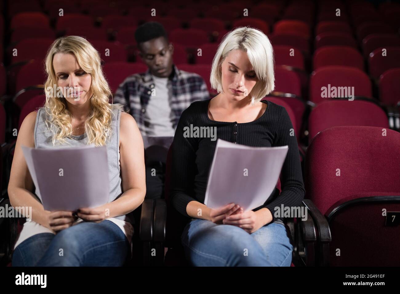 Actors reading their scripts on stage in theatre Stock Photo - Alamy