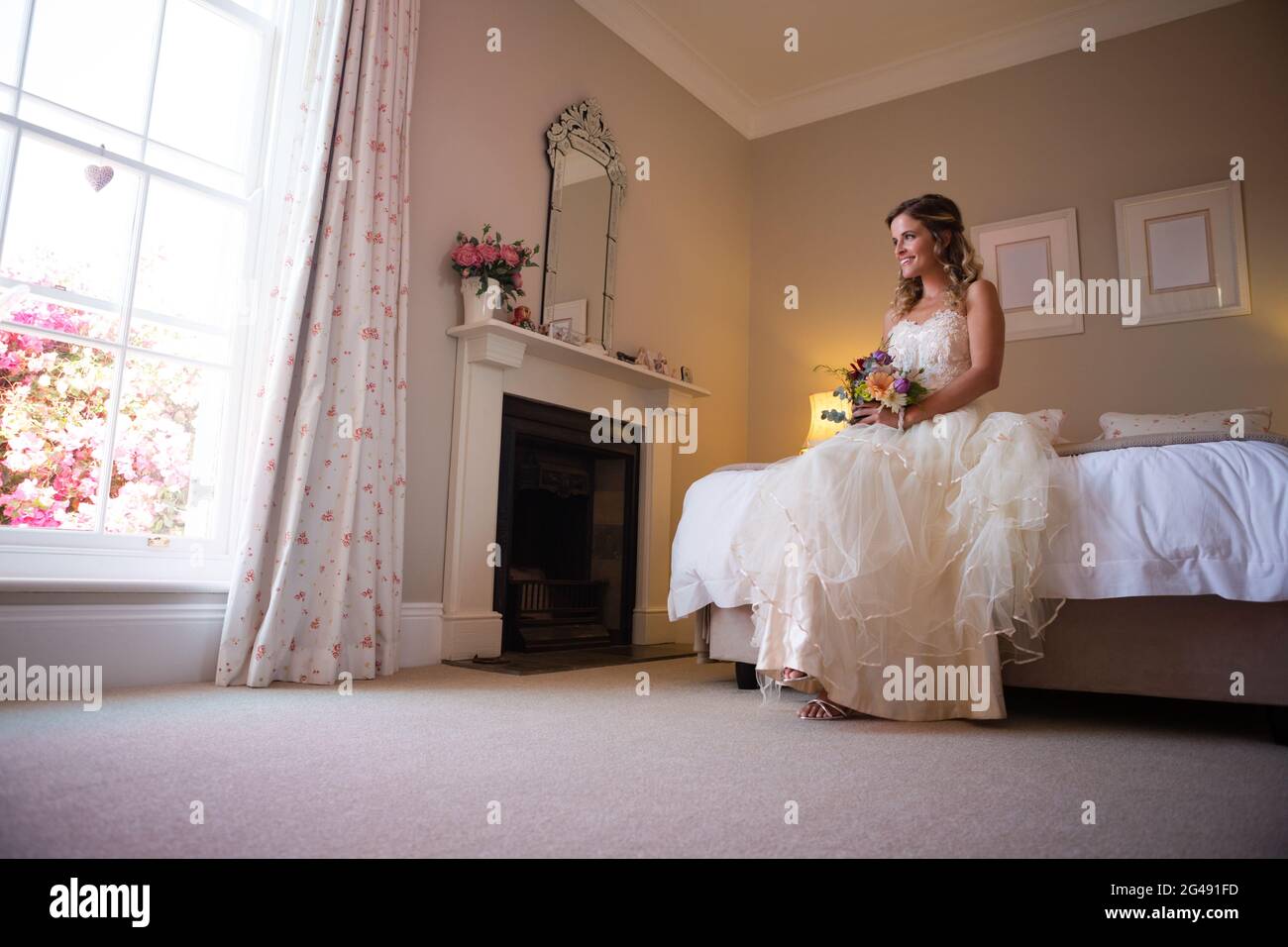 Bride sitting on bed hi-res stock photography and images - Alamy