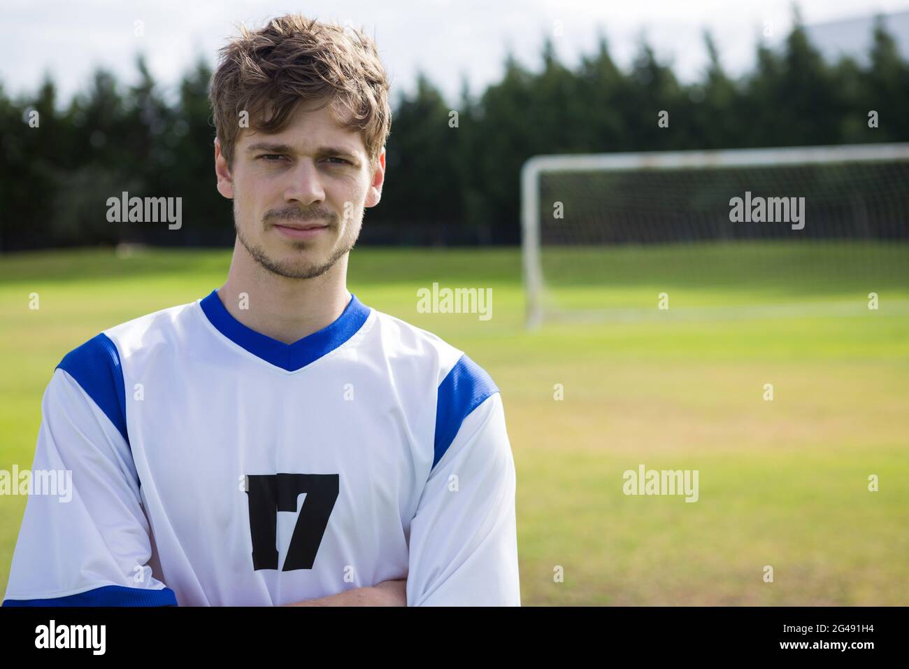 Portrait of Confident male soccer player Stock Photo - Alamy