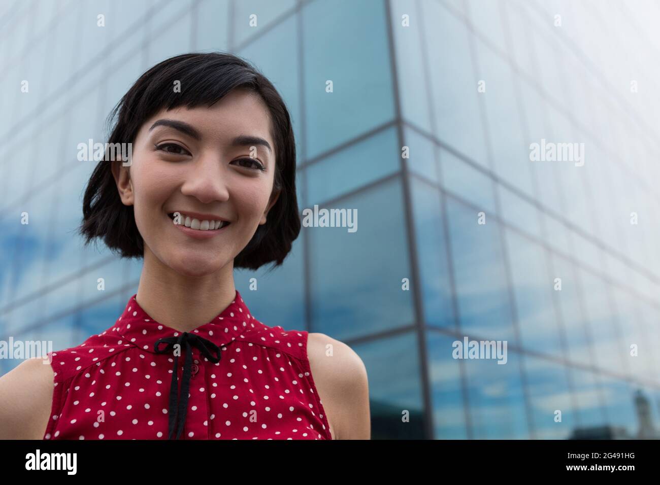 Female executive standing in office premises Stock Photo - Alamy