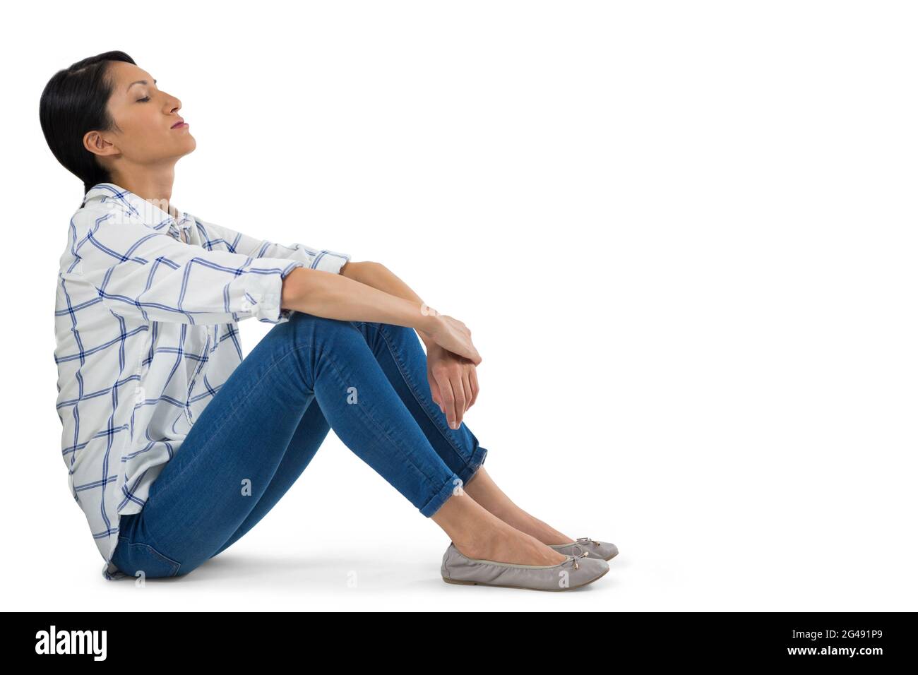 Woman relaxing against white background Stock Photo - Alamy