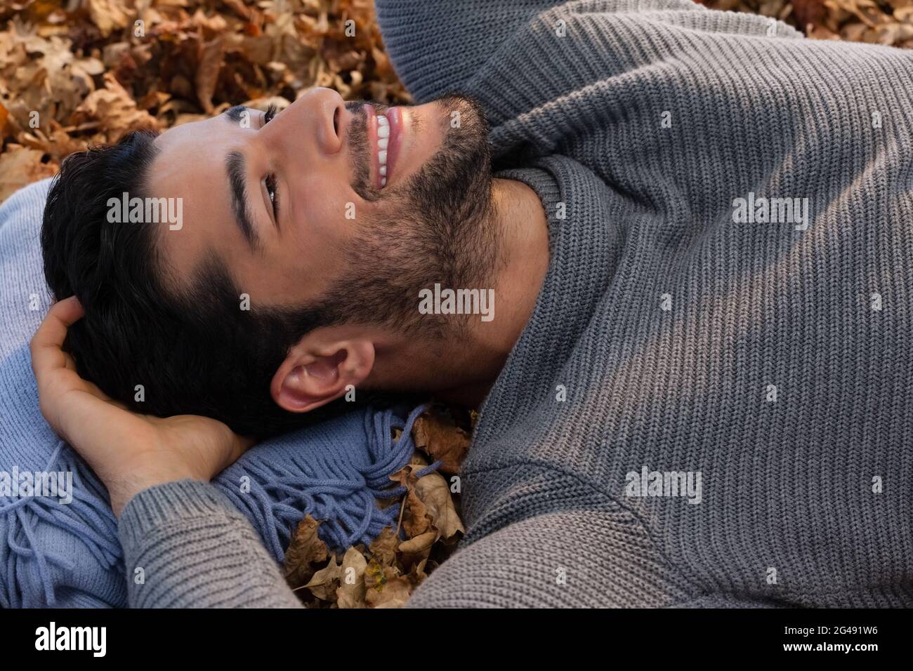 Overhead of man lying on autumn leaves Stock Photo - Alamy