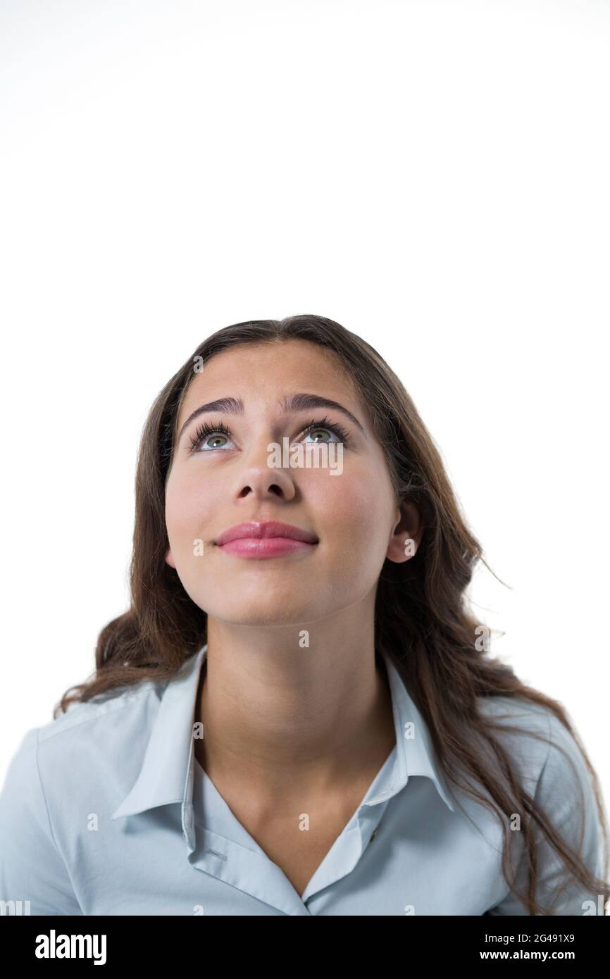 Thoughtful female executive against white background Stock Photo - Alamy