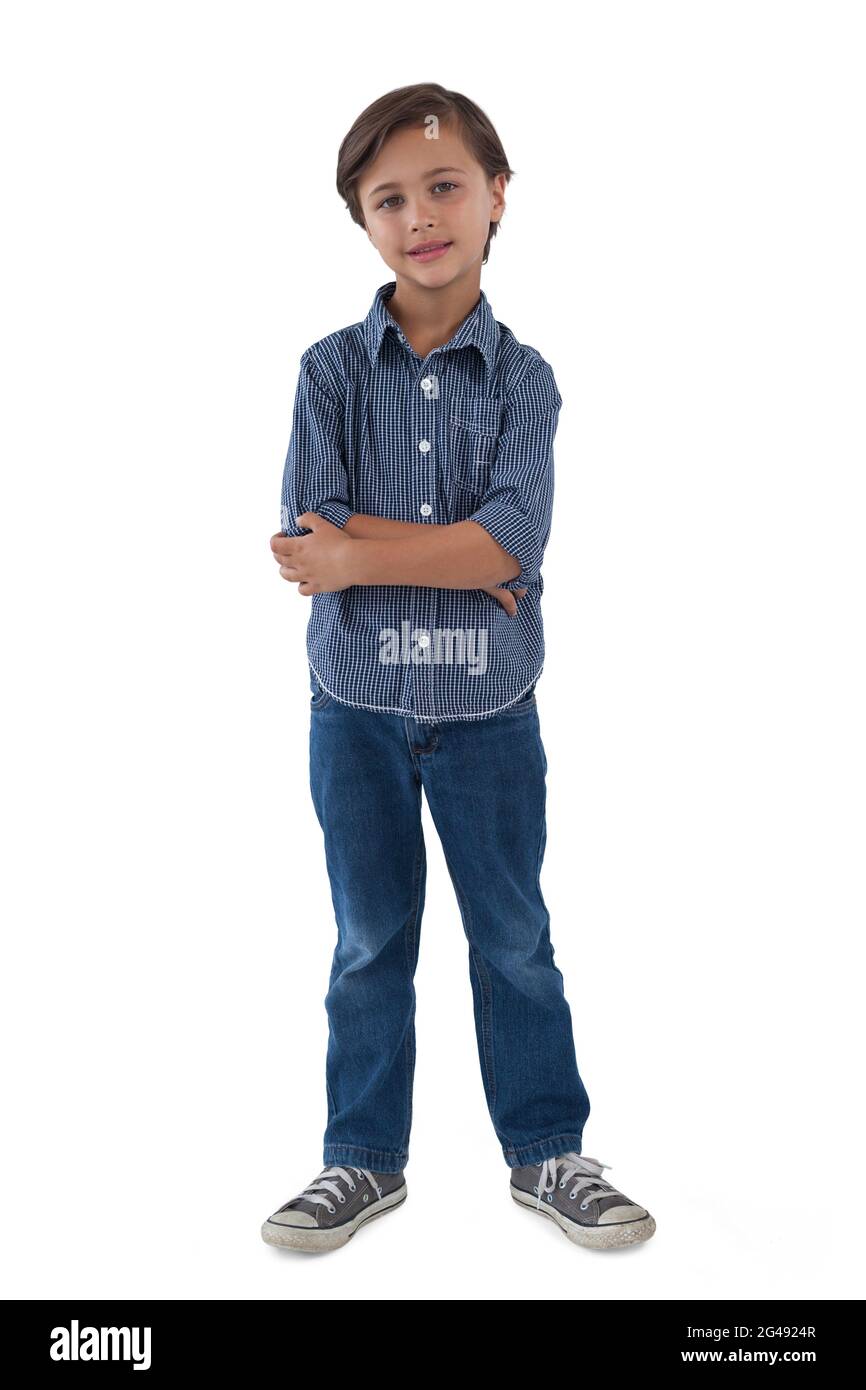 Boy standing with arms crossed against white background Stock Photo - Alamy