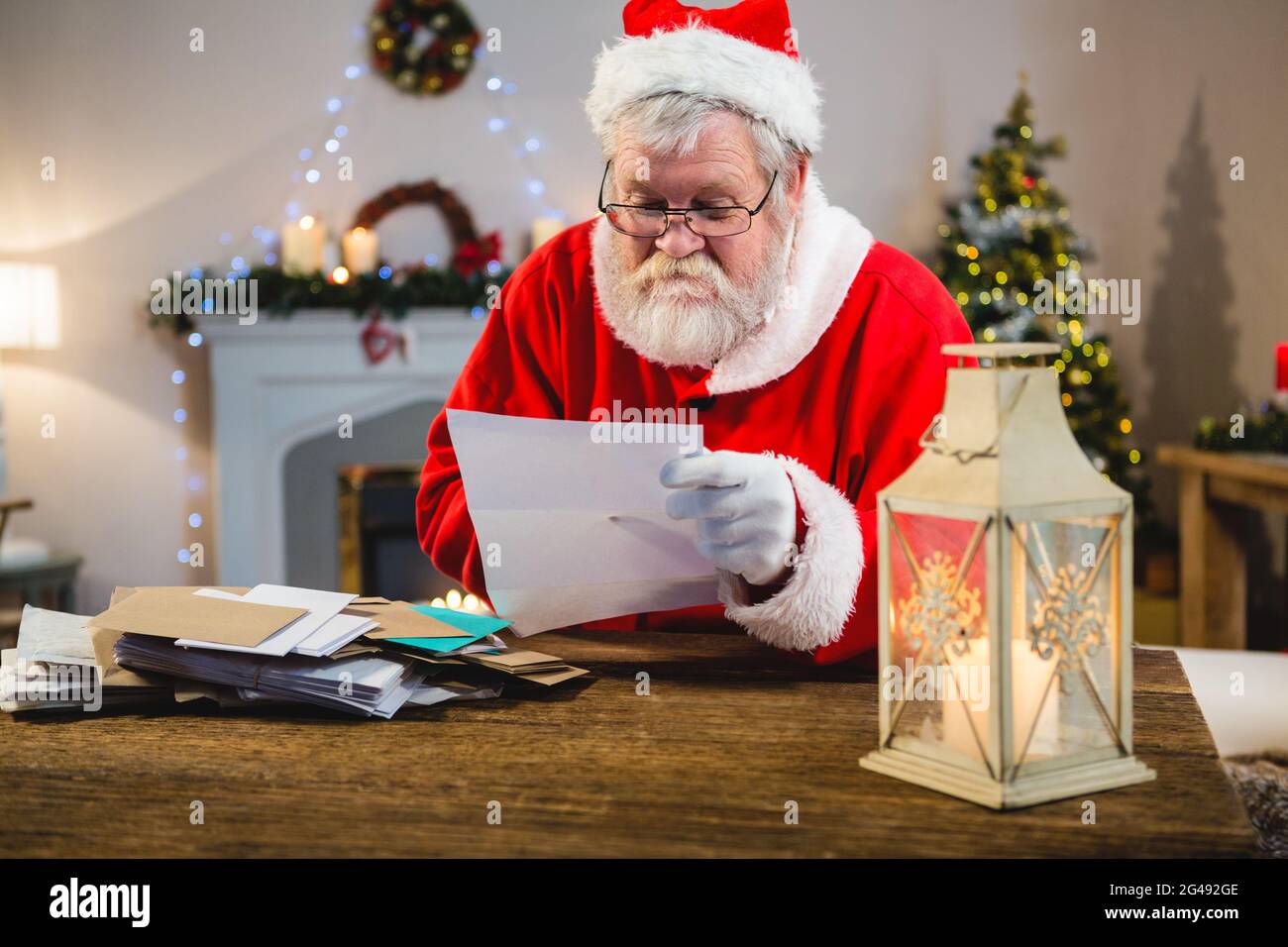 Santa Claus reading a letter Stock Photo - Alamy