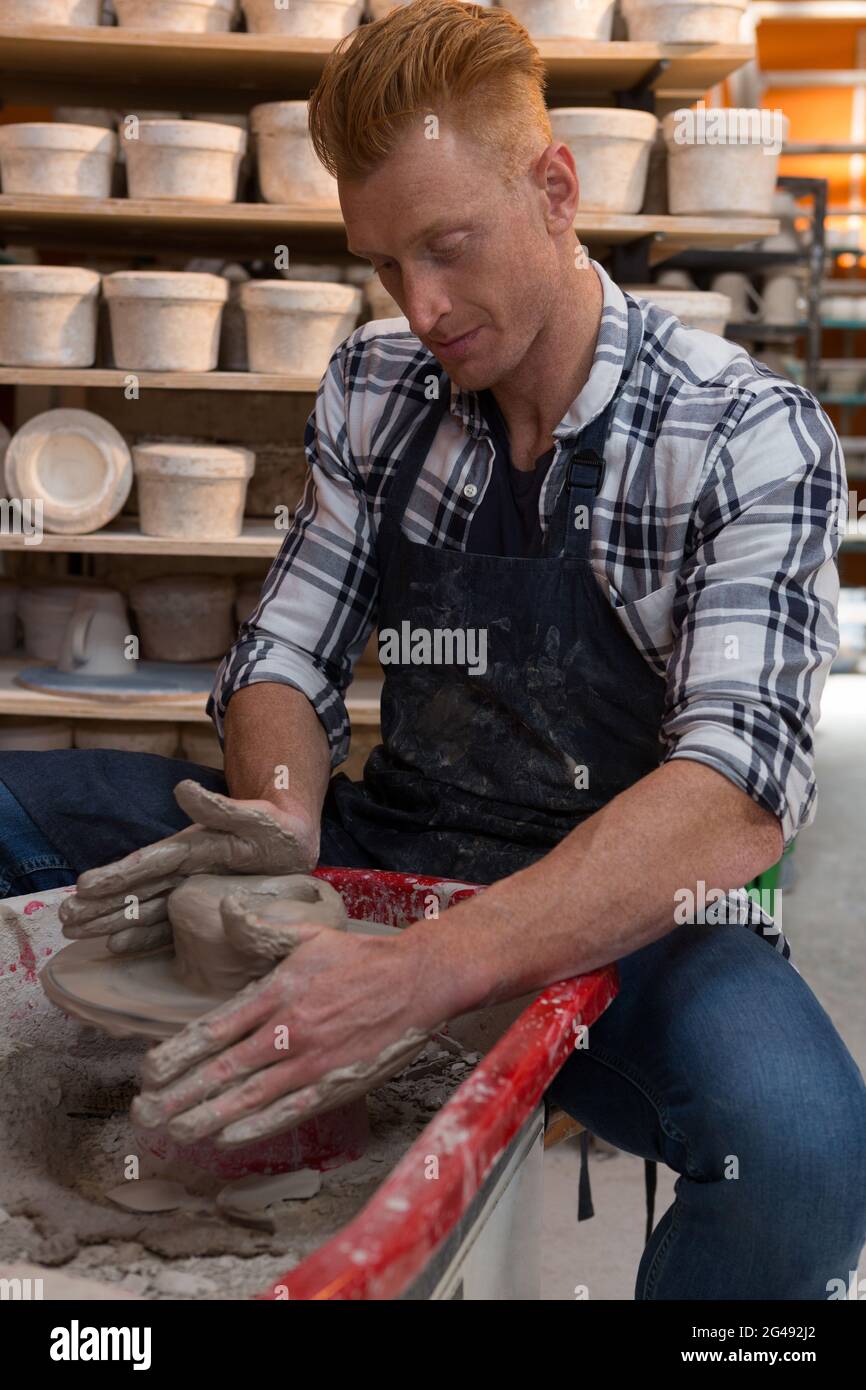 Mid adult man sitting pottery hi-res stock photography and images - Alamy