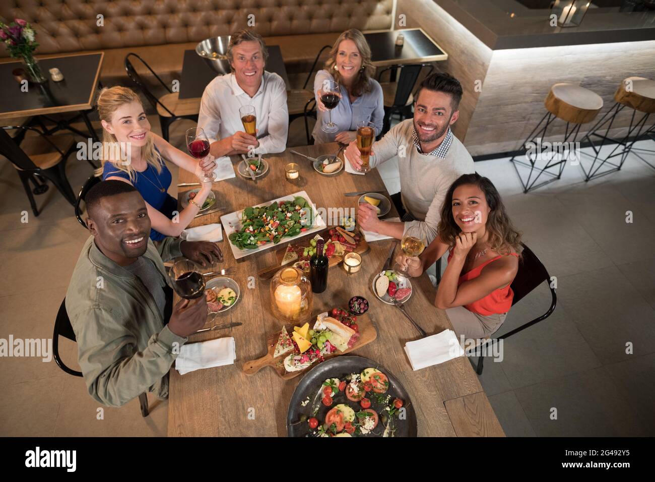 Overhead of happy friends dining together Stock Photo - Alamy