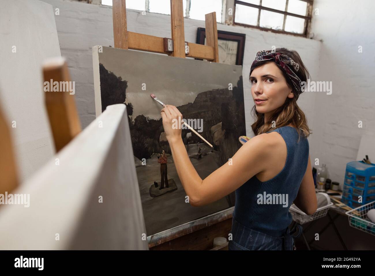 Woman painting on canvas in drawing class Stock Photo - Alamy