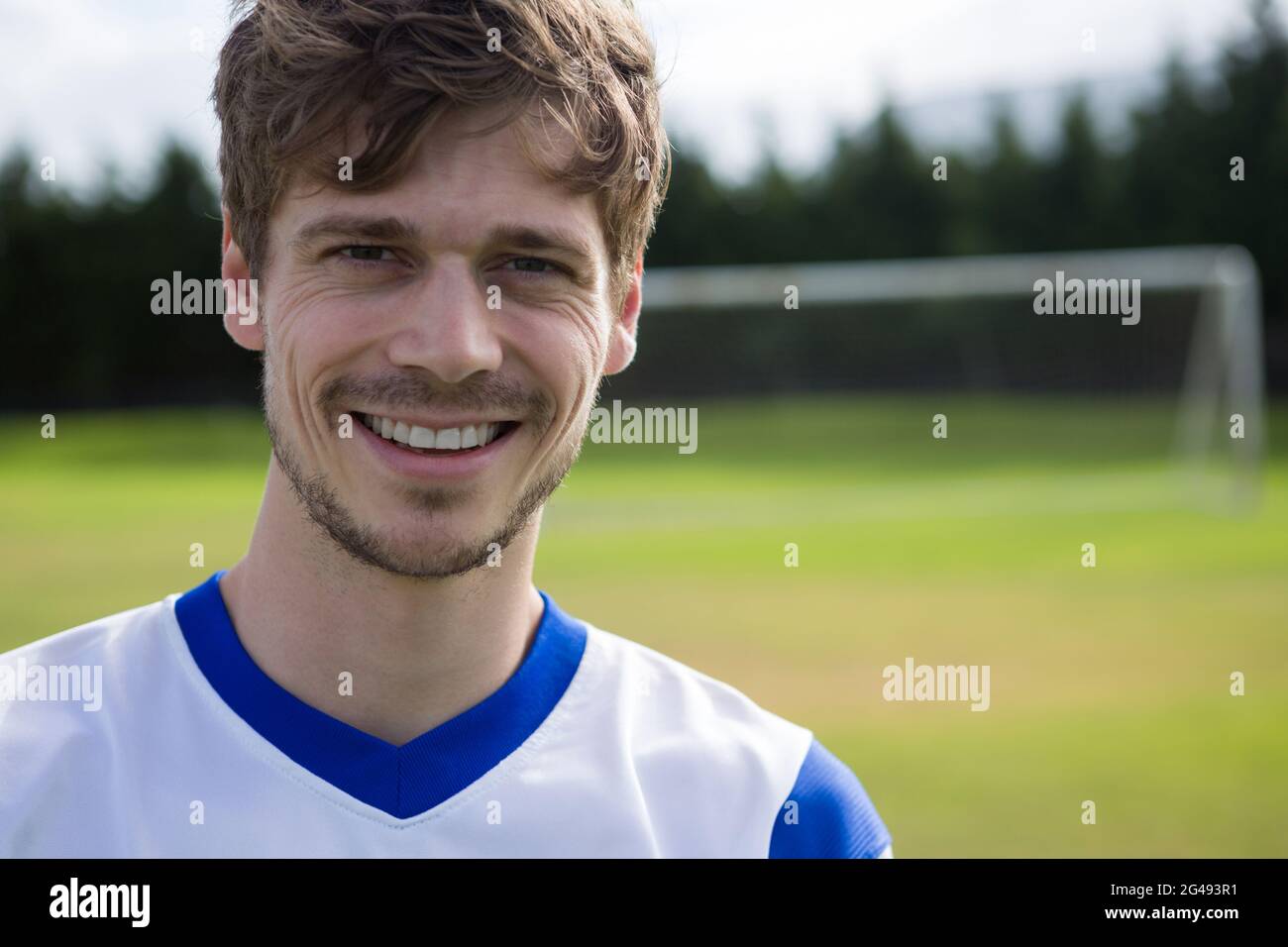 Professional sportsperson looking at camera standing smiling confidence ...