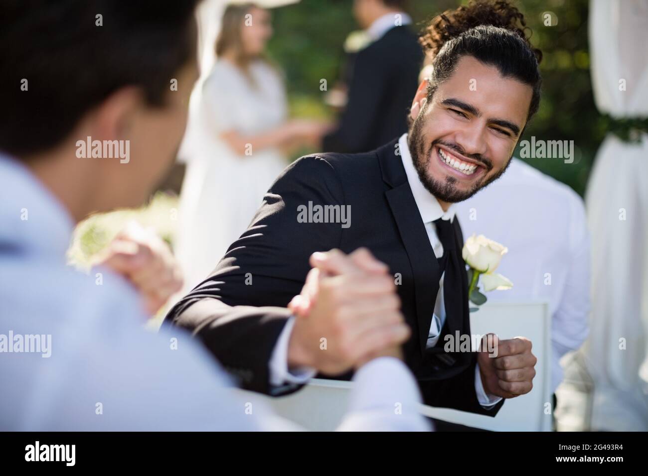 Man shaking hand with waiter during wedding Stock Photo - Alamy