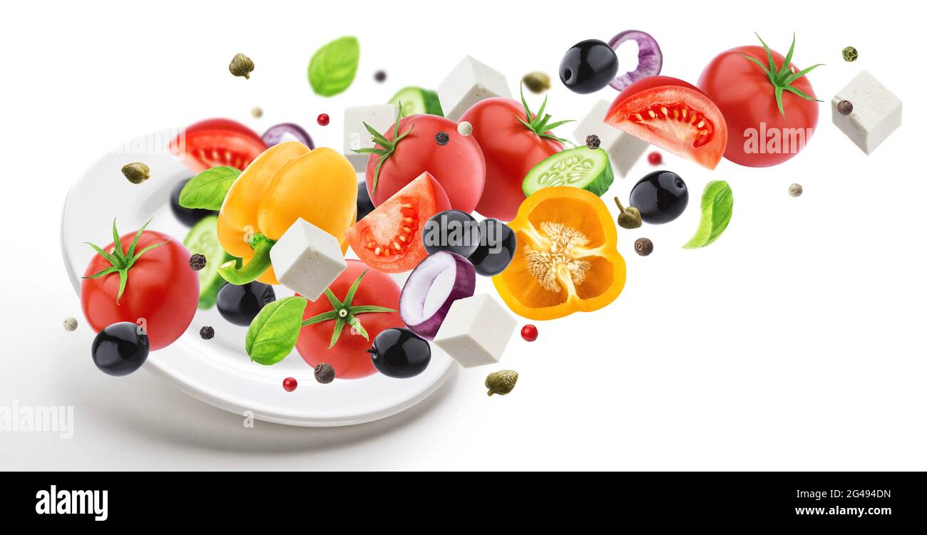 Plate with falling greek salad isolated on white background Stock Photo ...